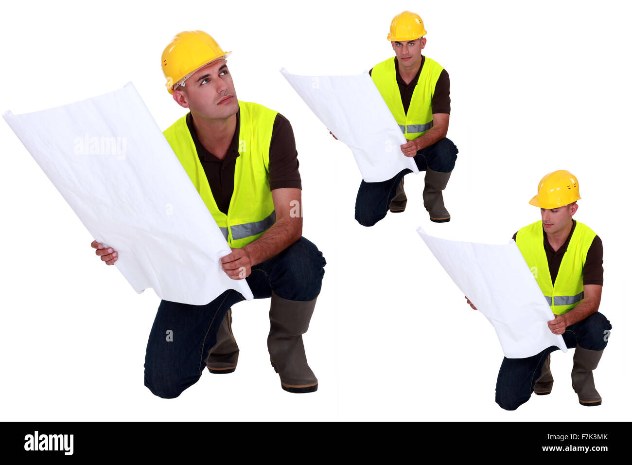 Foreman with plans kneeling Stock Photo - Alamy