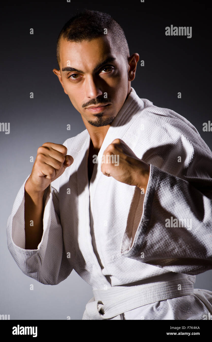 Karate player in dark room Stock Photo - Alamy
