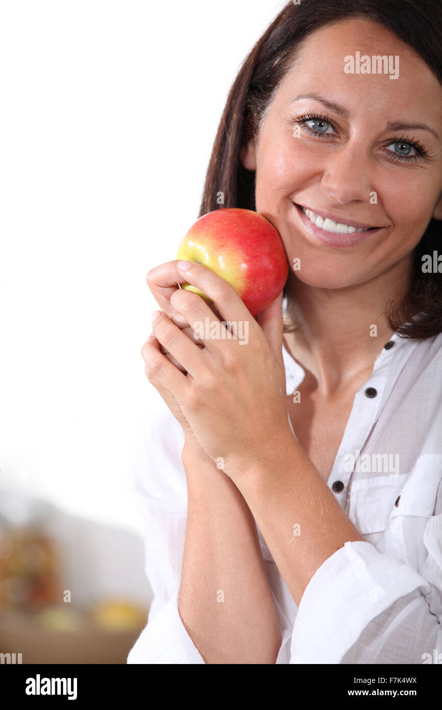 Woman with an apple Stock Photo - Alamy