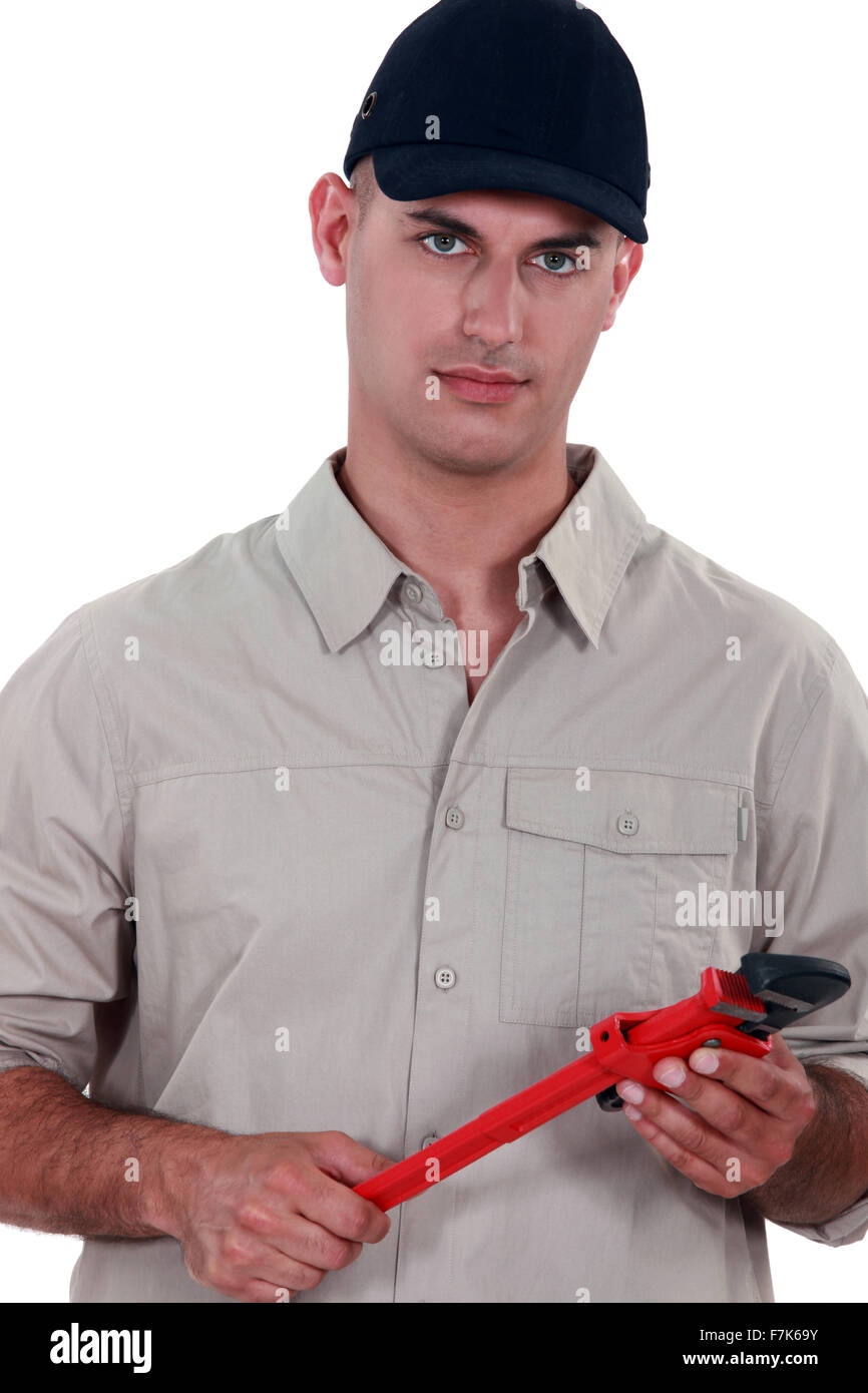 Handyman holding a wrench Stock Photo - Alamy
