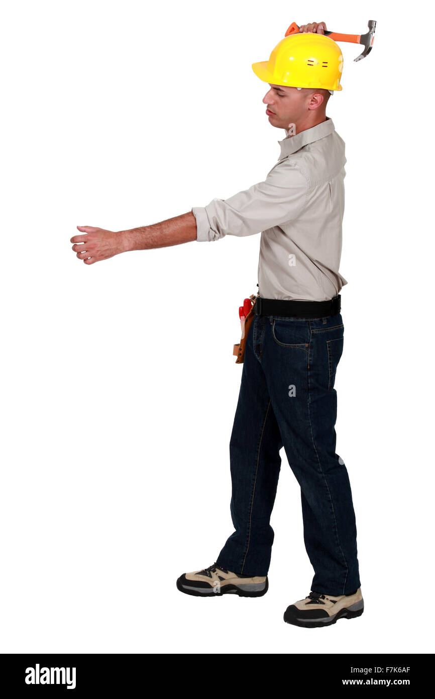 Builder holding hammer over head Stock Photo - Alamy