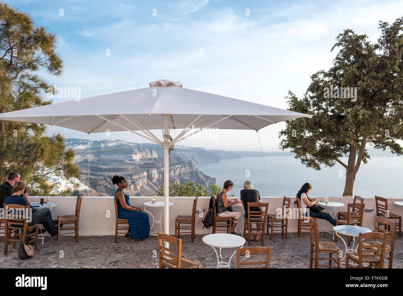 Greece, Santorini island, Fira, tourists in a coffee bar on caldera ...
