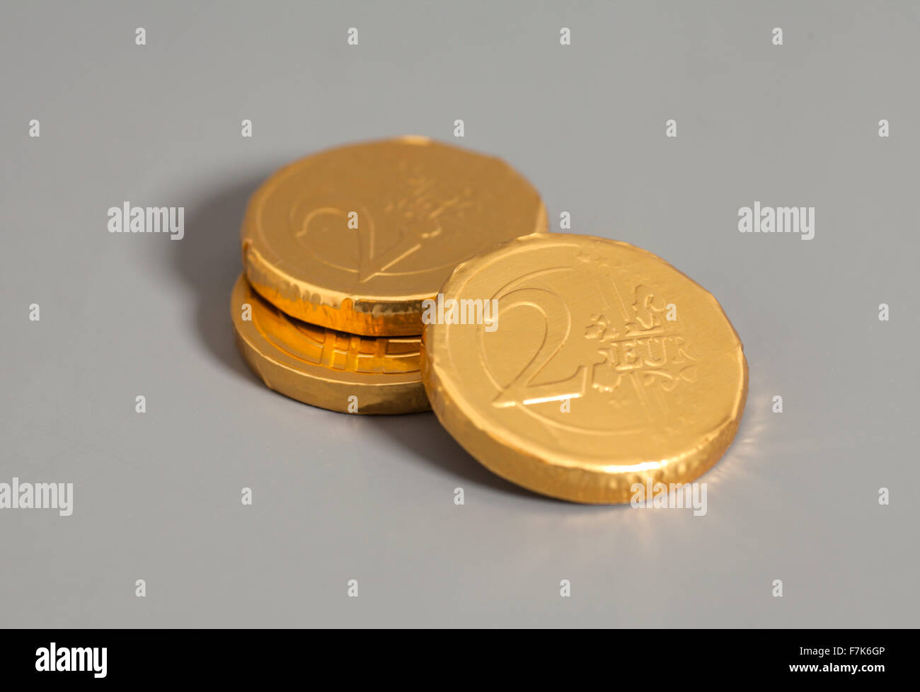 Golden euro coins on gray background Stock Photo - Alamy