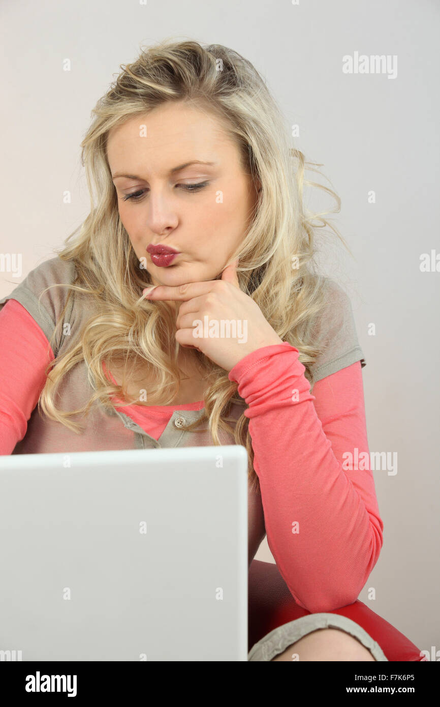 Blonde woman undecided Stock Photo - Alamy