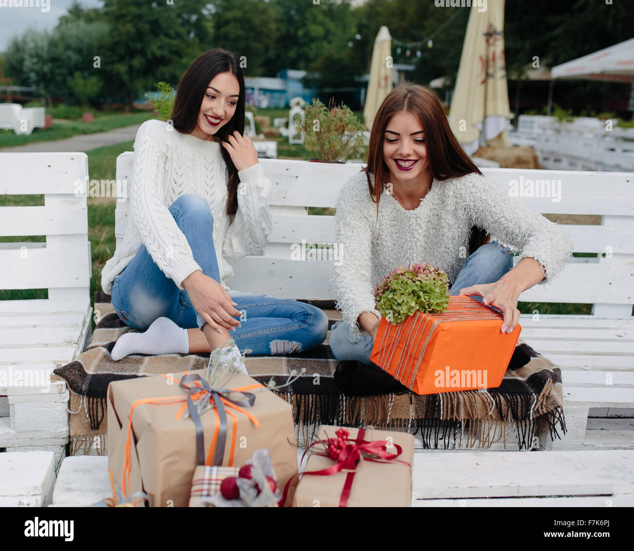 Two beautiful girls holding gifts Stock Photo - Alamy
