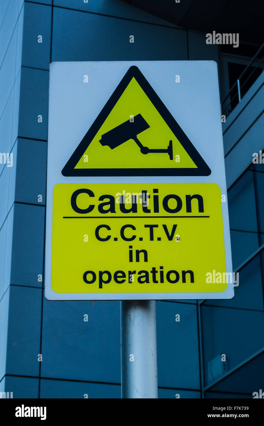 A yellow caution cctv in operation sign Stock Photo - Alamy