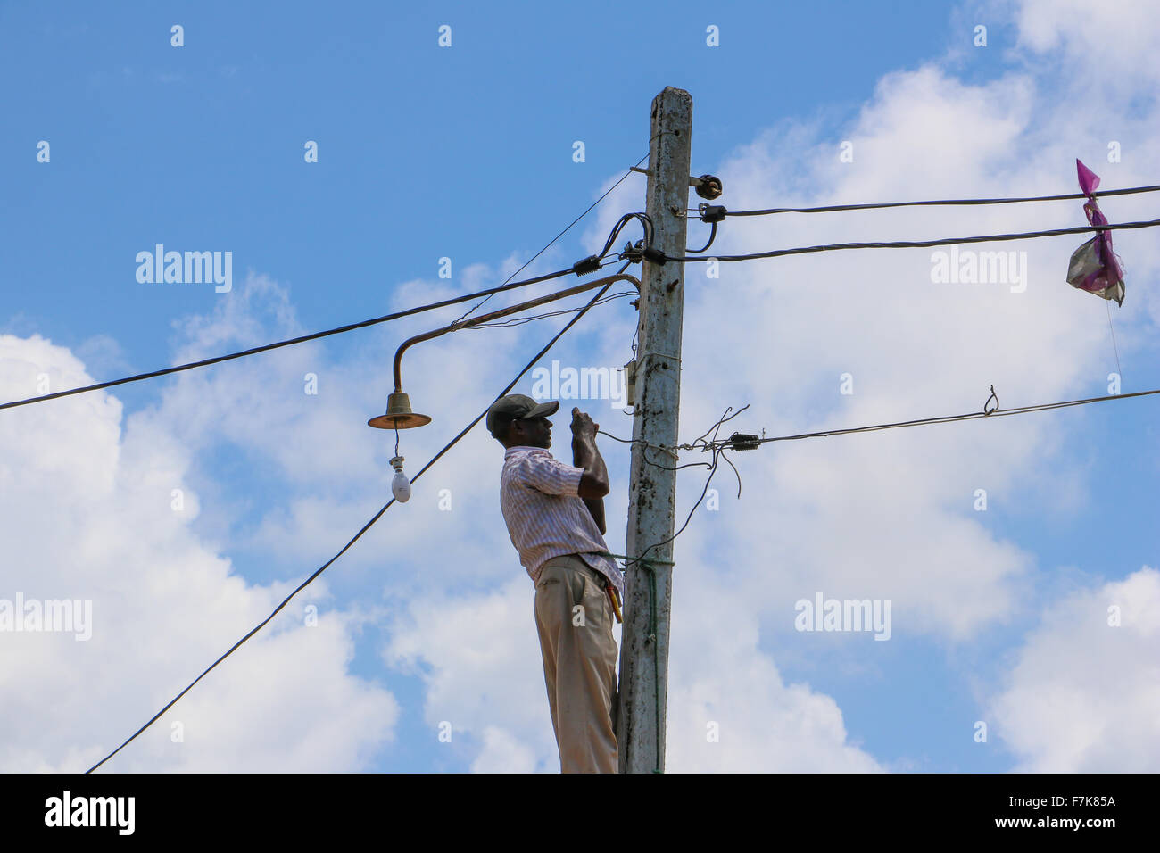 Hard at work fixing a telephone line. Galle, Sri Lanka Stock Photo - Alamy