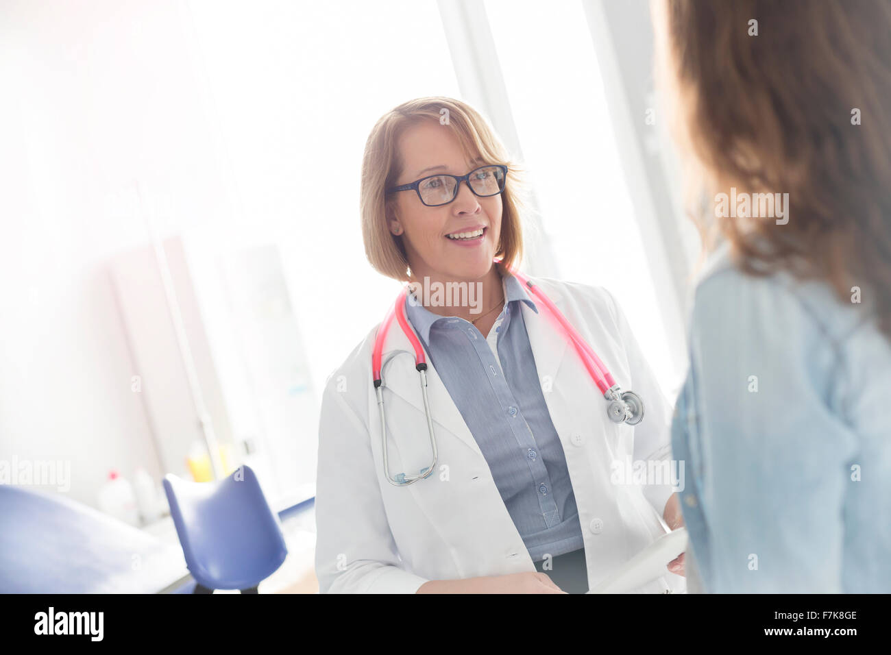Doctor and patient talking in examination room Stock Photo - Alamy
