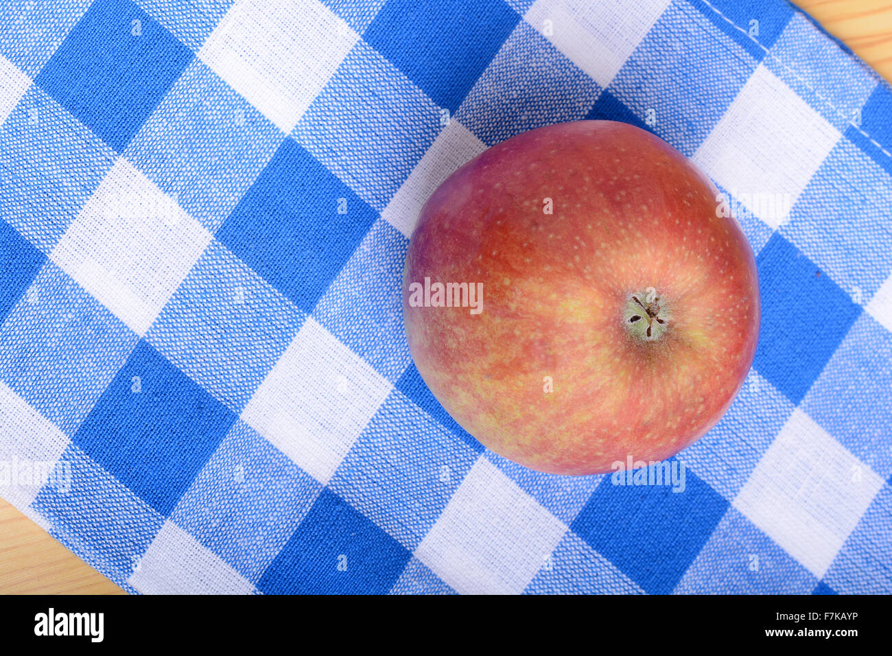 Red apple top view on blue material background Stock Photo - Alamy