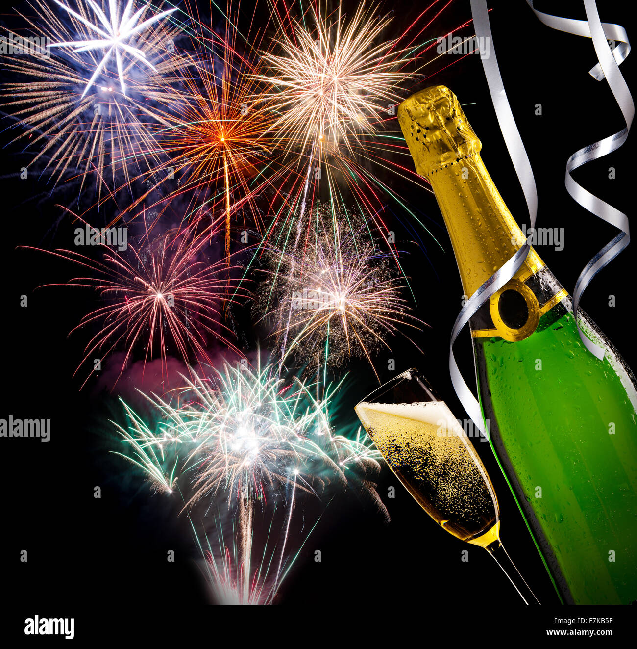 Glass of champagne with bottle with fireworks Stock Photo - Alamy