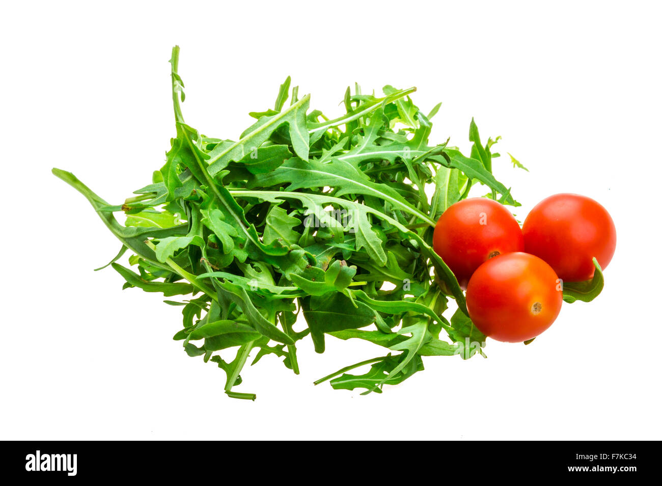 Ruccola with tomato cherry isolated Stock Photo - Alamy