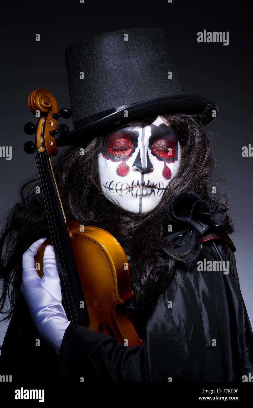 Monster playing violin in dark room Stock Photo - Alamy
