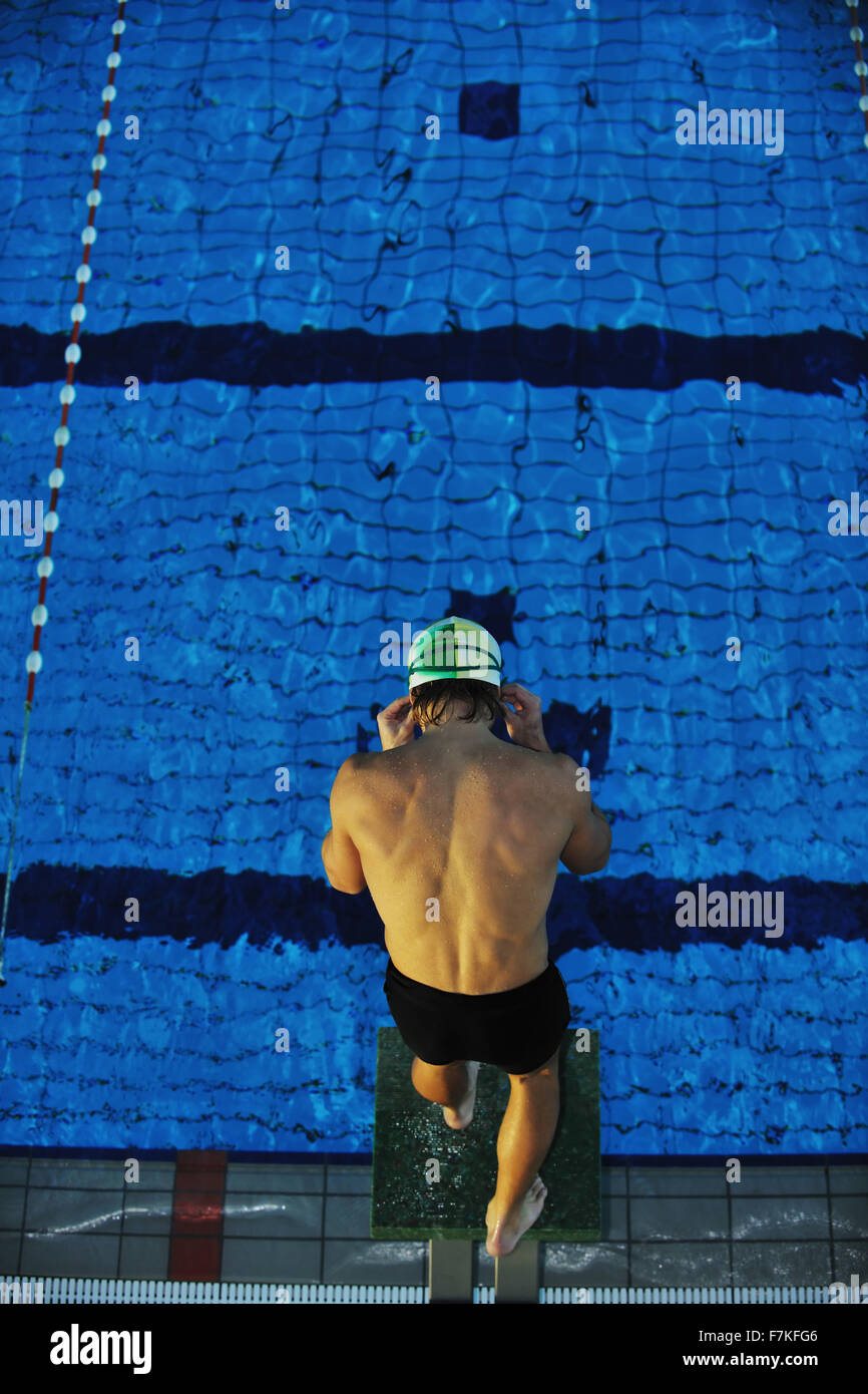 start position race concept with fit swimmer on swimming pool Stock ...