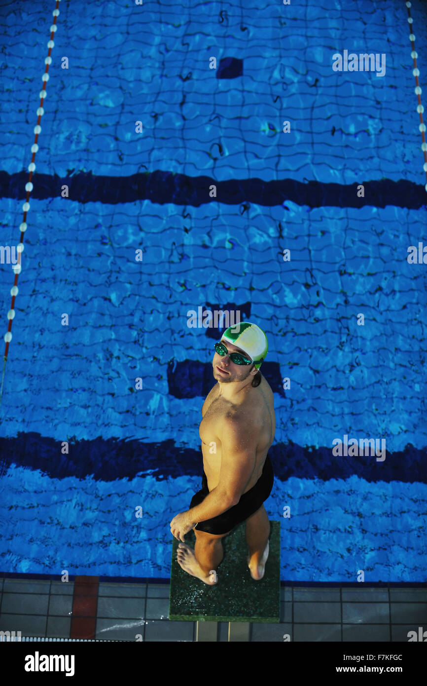 start position race concept with fit swimmer on swimming pool Stock ...