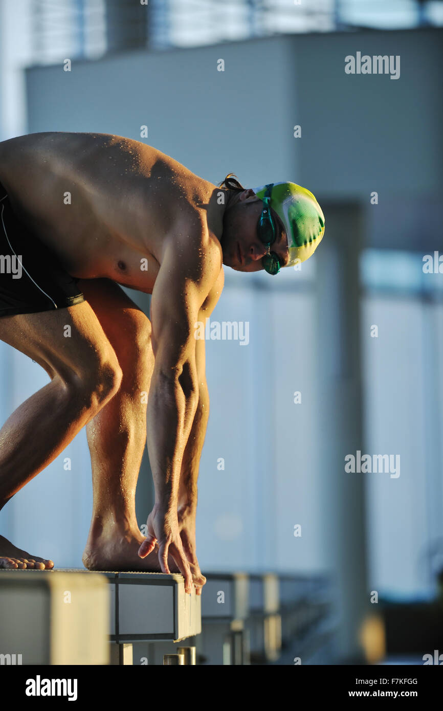 start position race concept with fit swimmer on swimming pool Stock ...