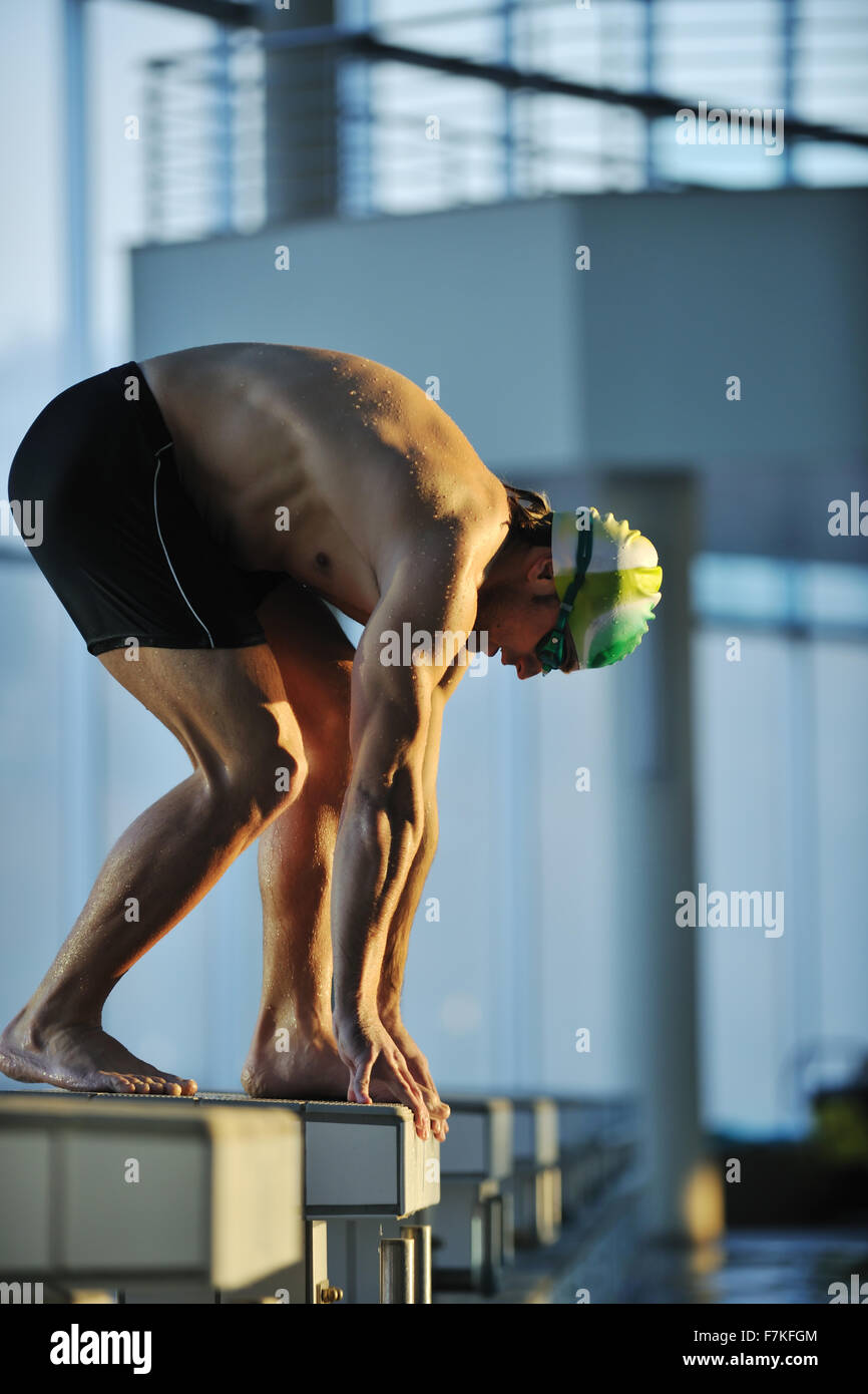 start position race concept with fit swimmer on swimming pool Stock ...
