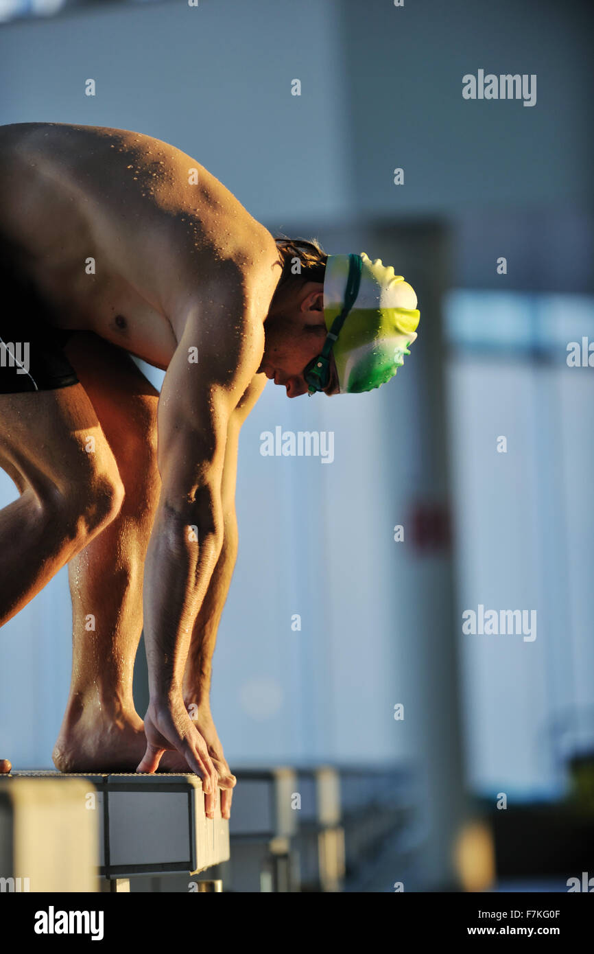 start position race concept with fit swimmer on swimming pool Stock ...