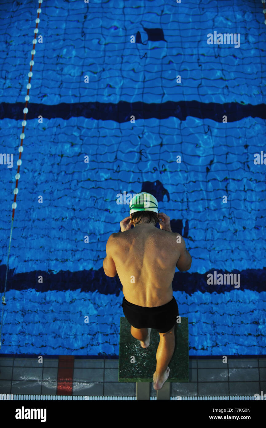 start position race concept with fit swimmer on swimming pool Stock ...