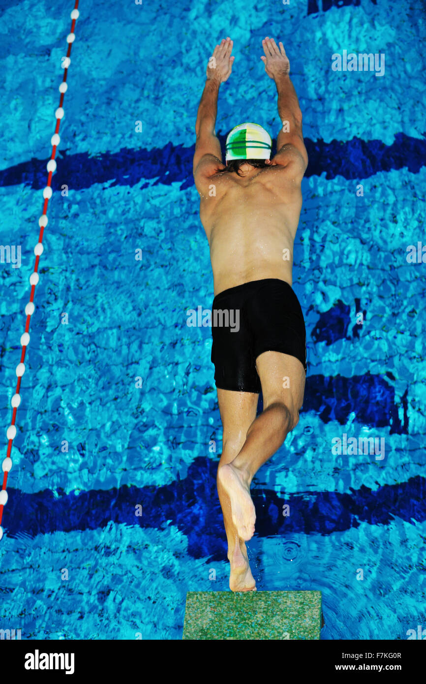 start position race concept with fit swimmer on swimming pool Stock ...