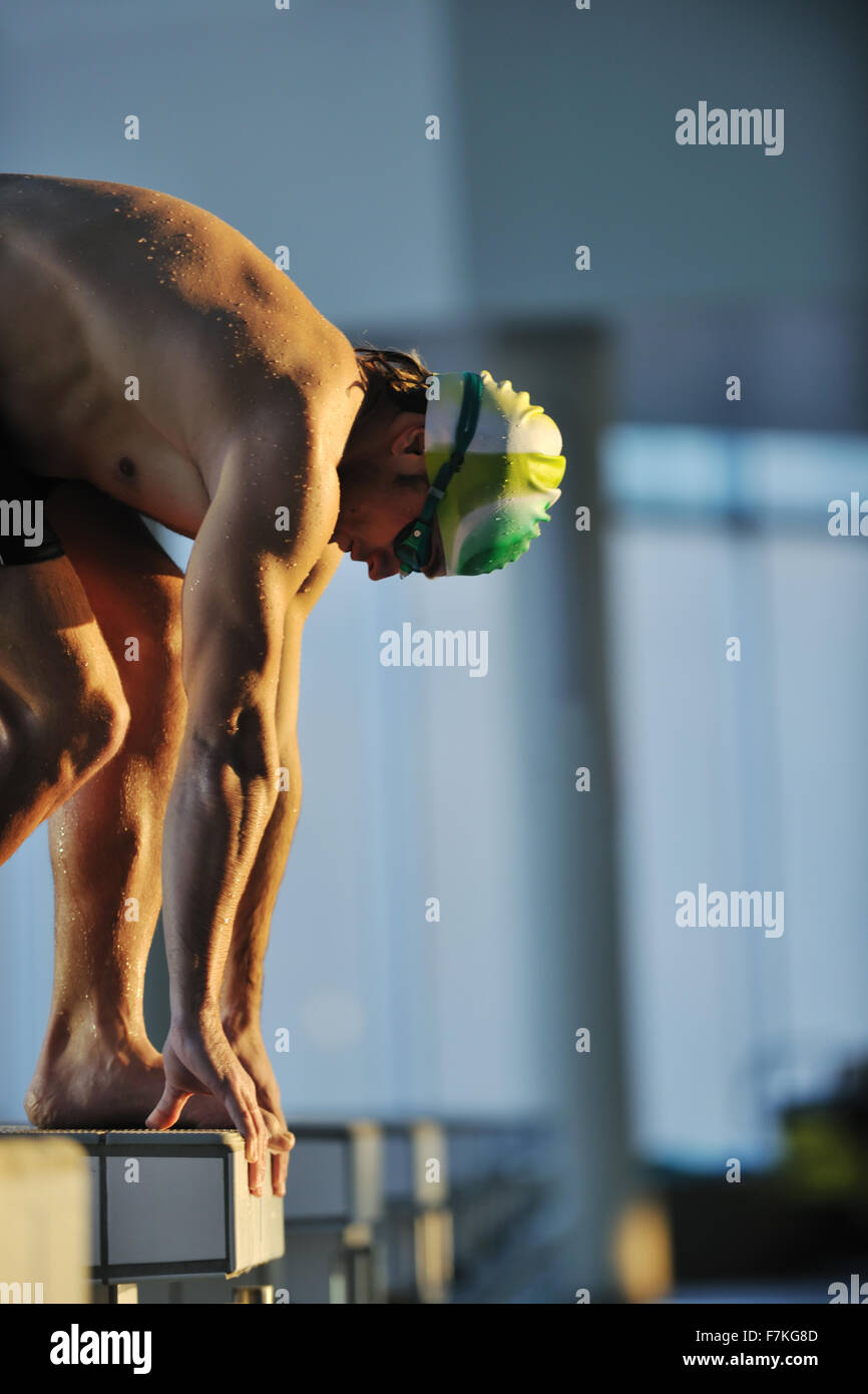 start position race concept with fit swimmer on swimming pool Stock ...