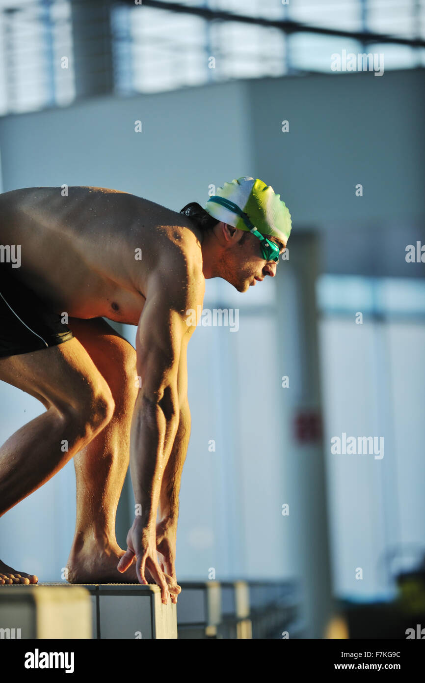 start position race concept with fit swimmer on swimming pool Stock ...