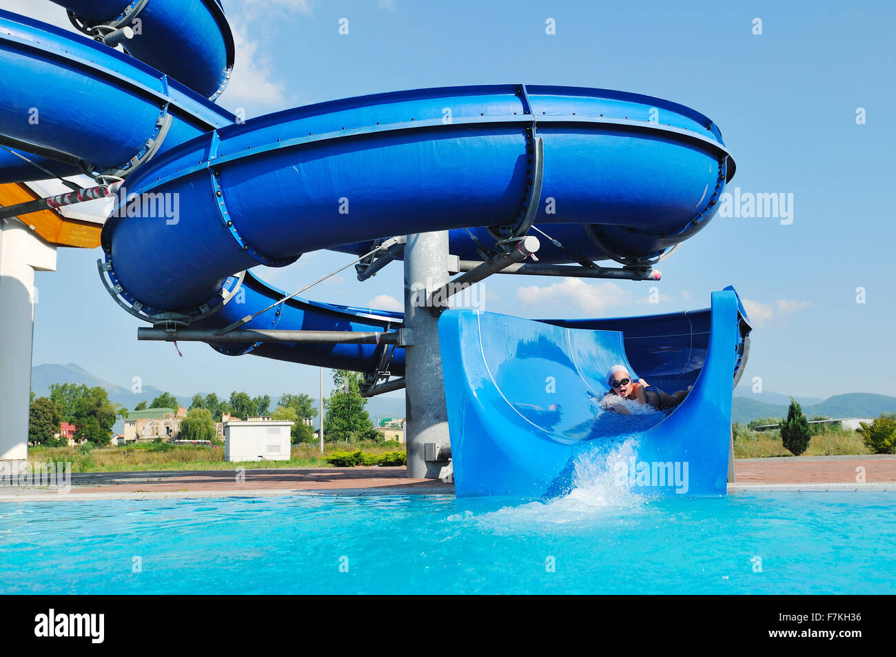 happy child have fun on water slike on outdoor swimming pool Stock ...