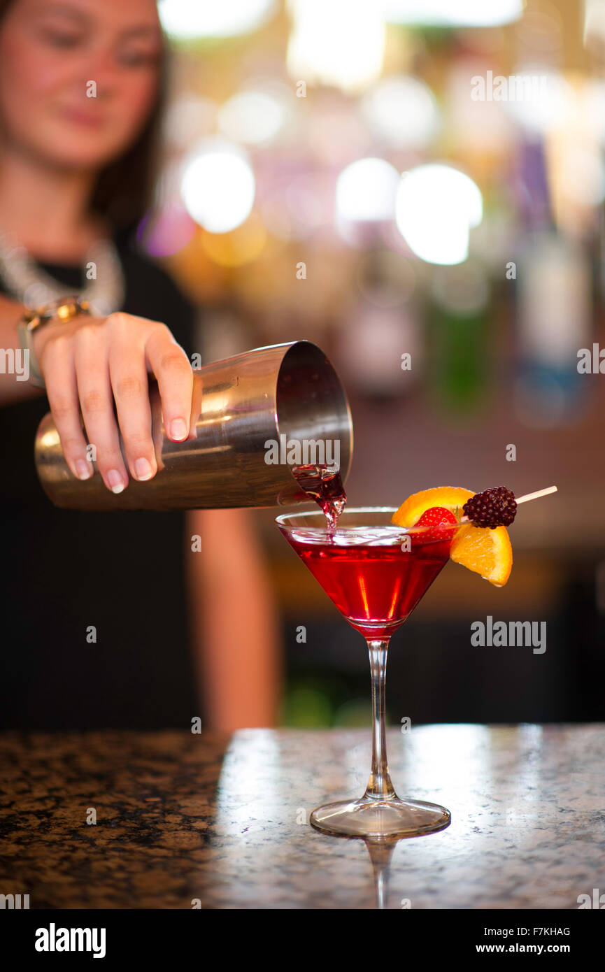 a girl pouring cocktails on a bar Stock Photo - Alamy
