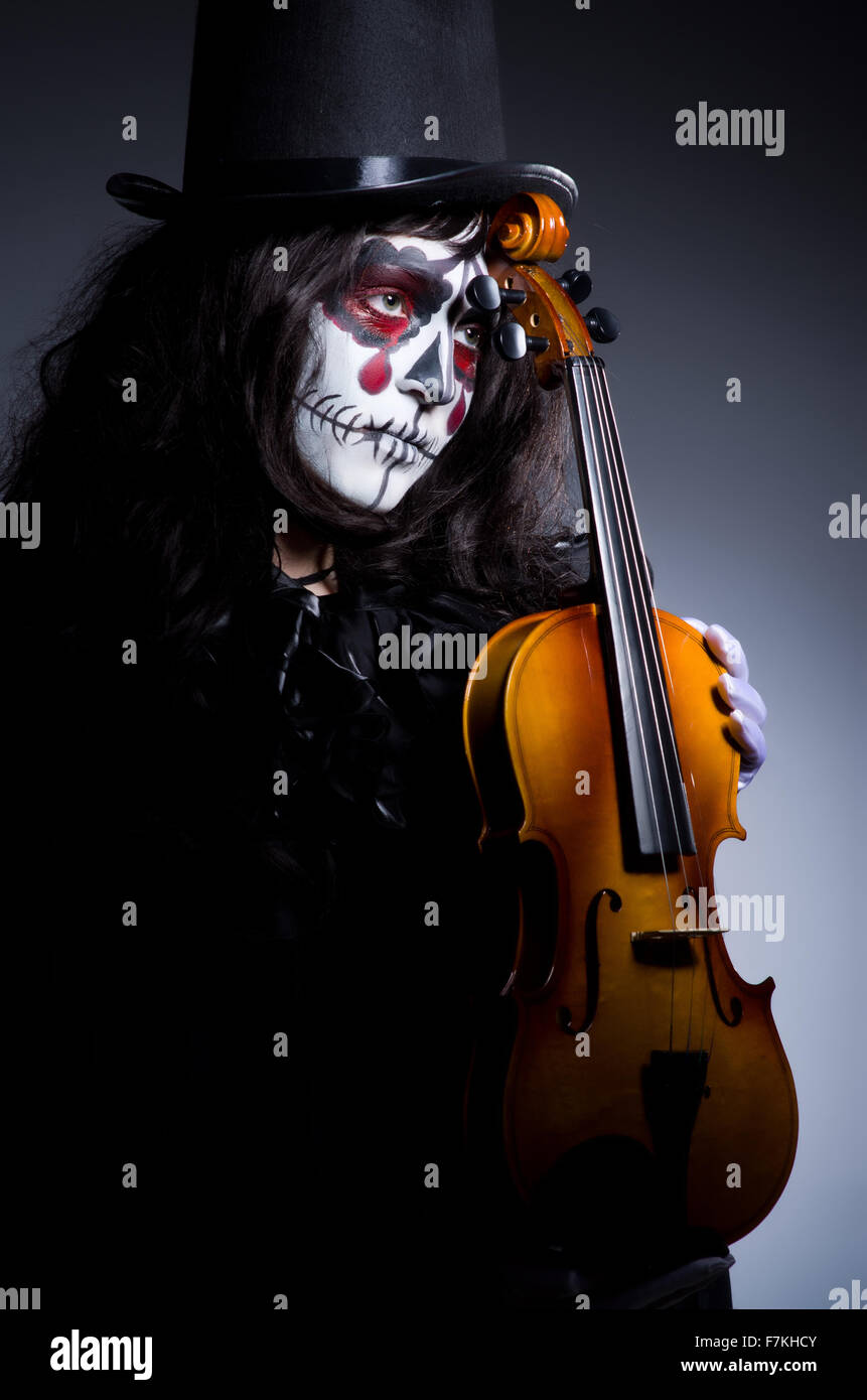 Monster playing violin in dark room Stock Photo - Alamy