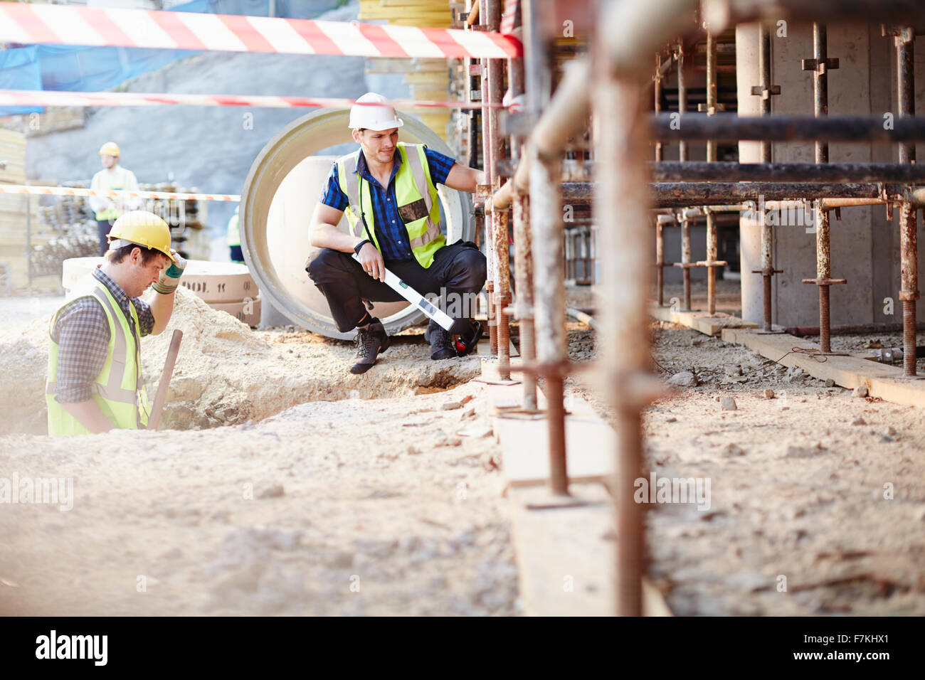 Construction workers working at construction site Stock Photo - Alamy