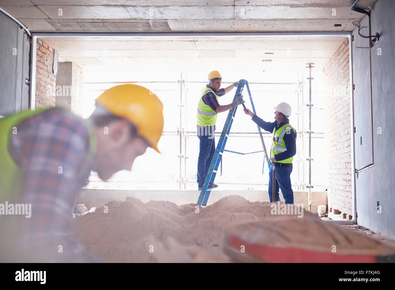 Construction worker on ladder at construction site Stock Photo - Alamy
