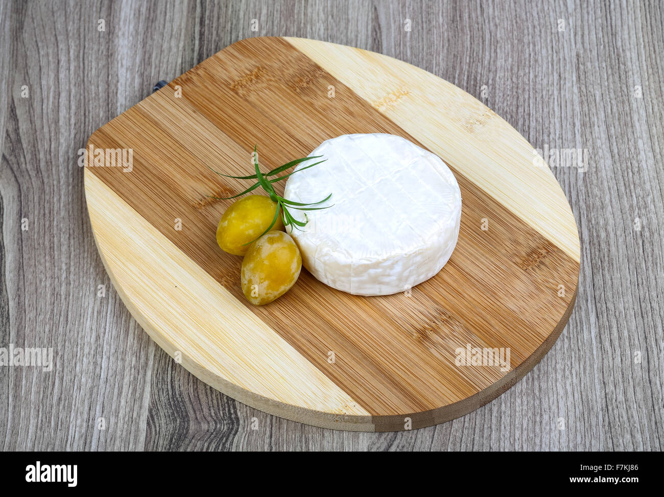 Round Brie cheese with yellow plums and estragon Stock Photo - Alamy