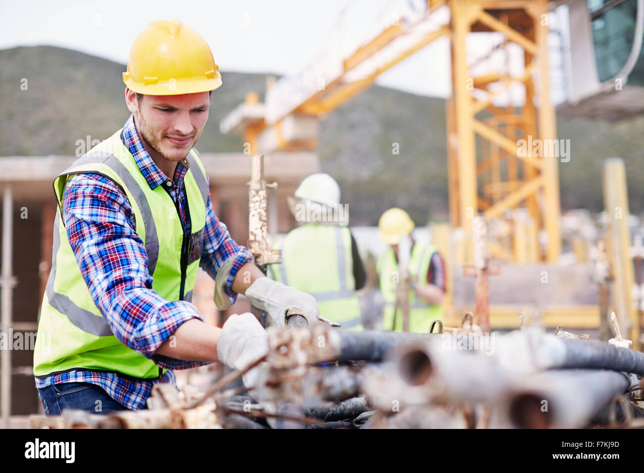 Construction worker working at construction site Stock Photo - Alamy