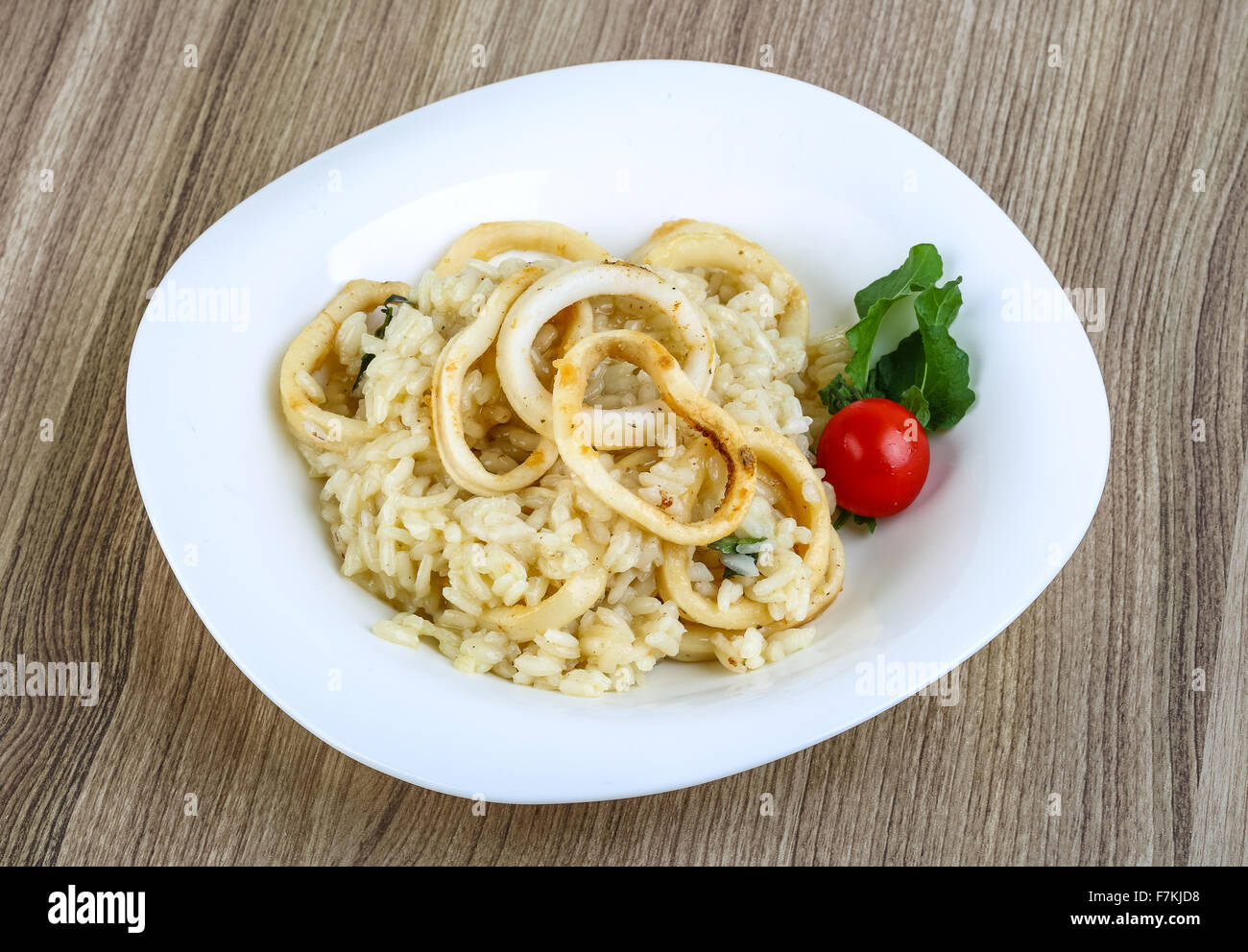 Italian famous cuisine - Squid risotto served basil leaves Stock Photo ...