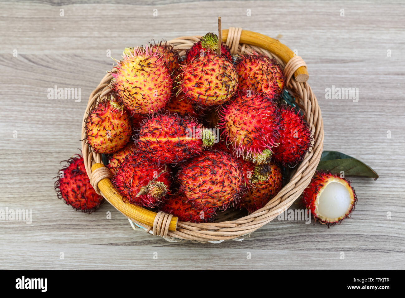 Asian fruit - rambutan - on the wood background Stock Photo - Alamy