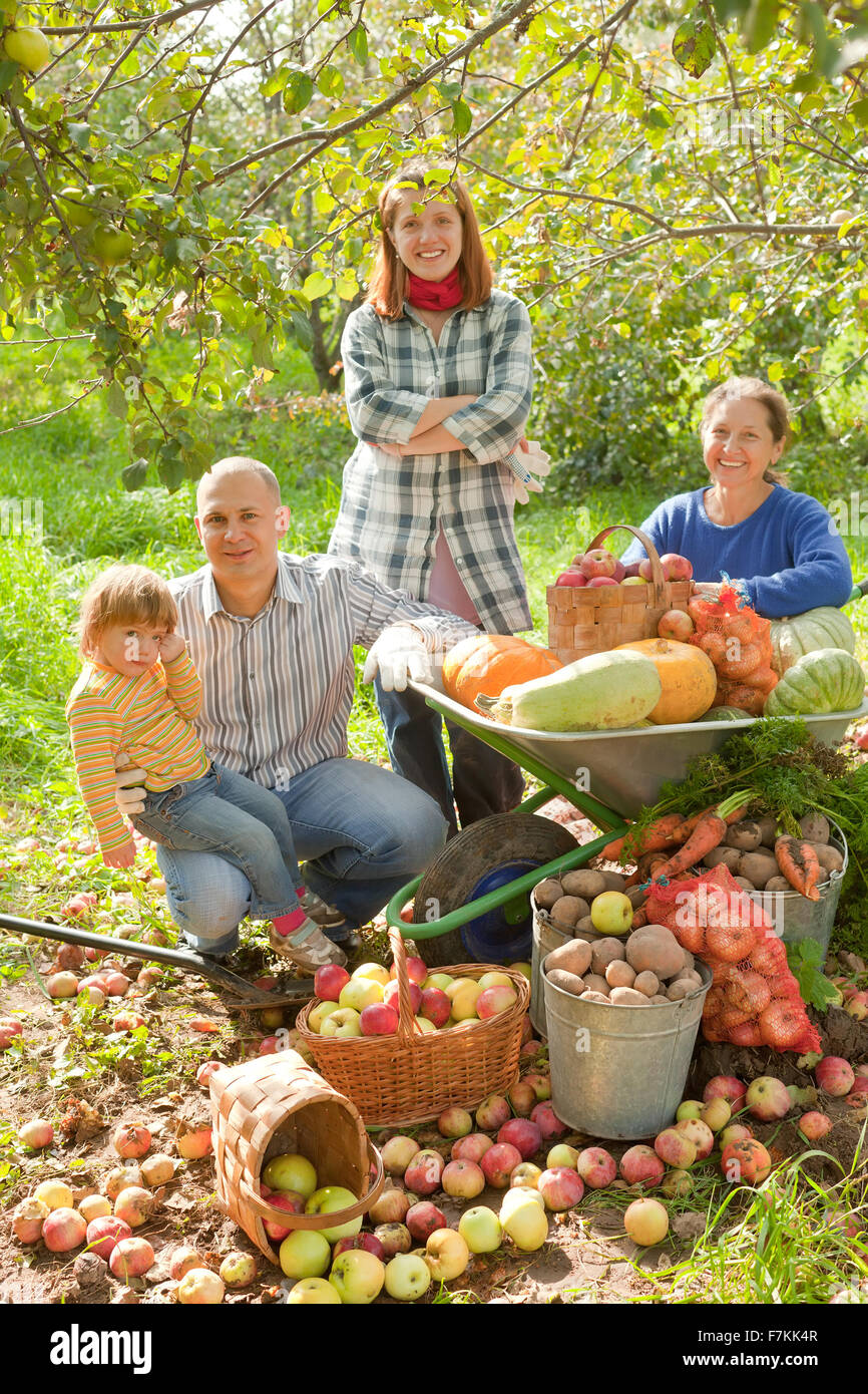 Happy family with vegetables harvest in garden Stock Photo - Alamy