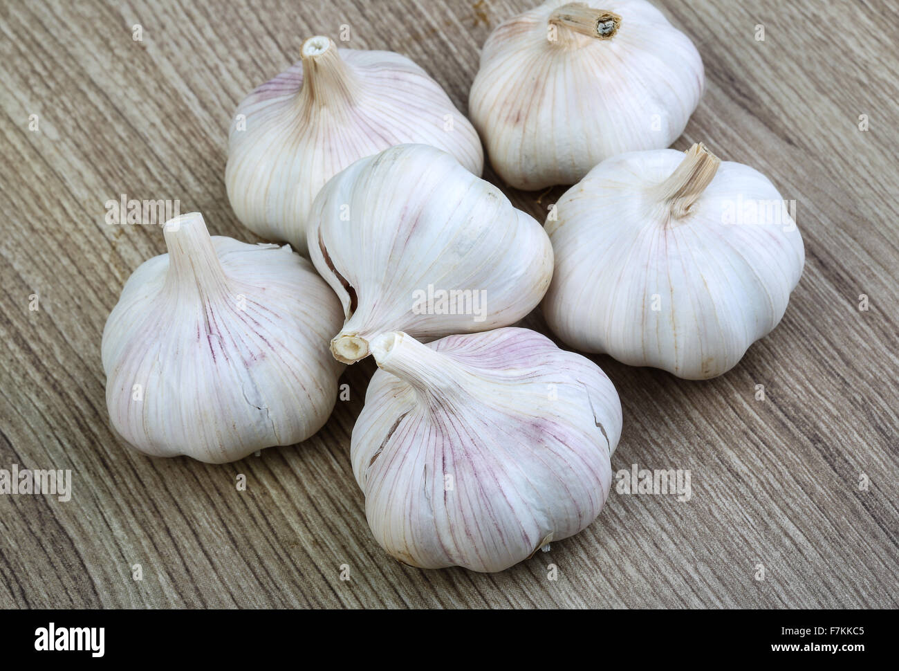 Fresh ripe Garlic heap on the wood background Stock Photo - Alamy