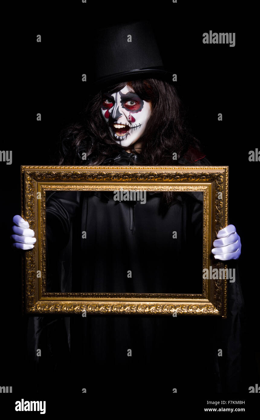 Monster with picture photo frame in dark room0 Stock Photo - Alamy