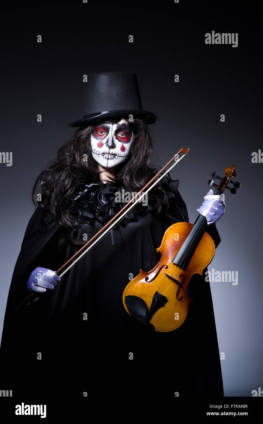 Monster playing violin in dark room Stock Photo - Alamy