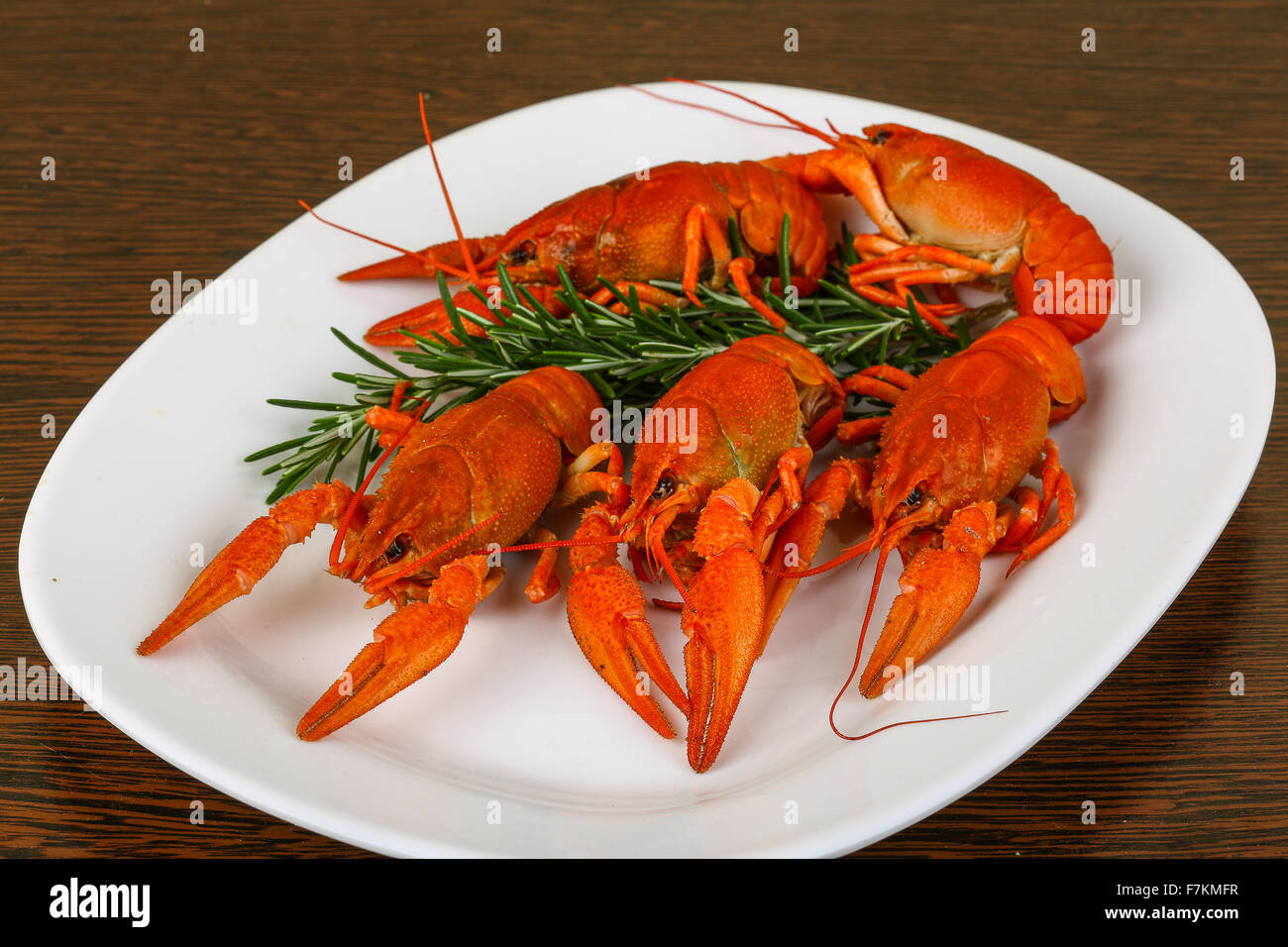 Boiled Crayfish with rosemary on the wood background Stock Photo - Alamy