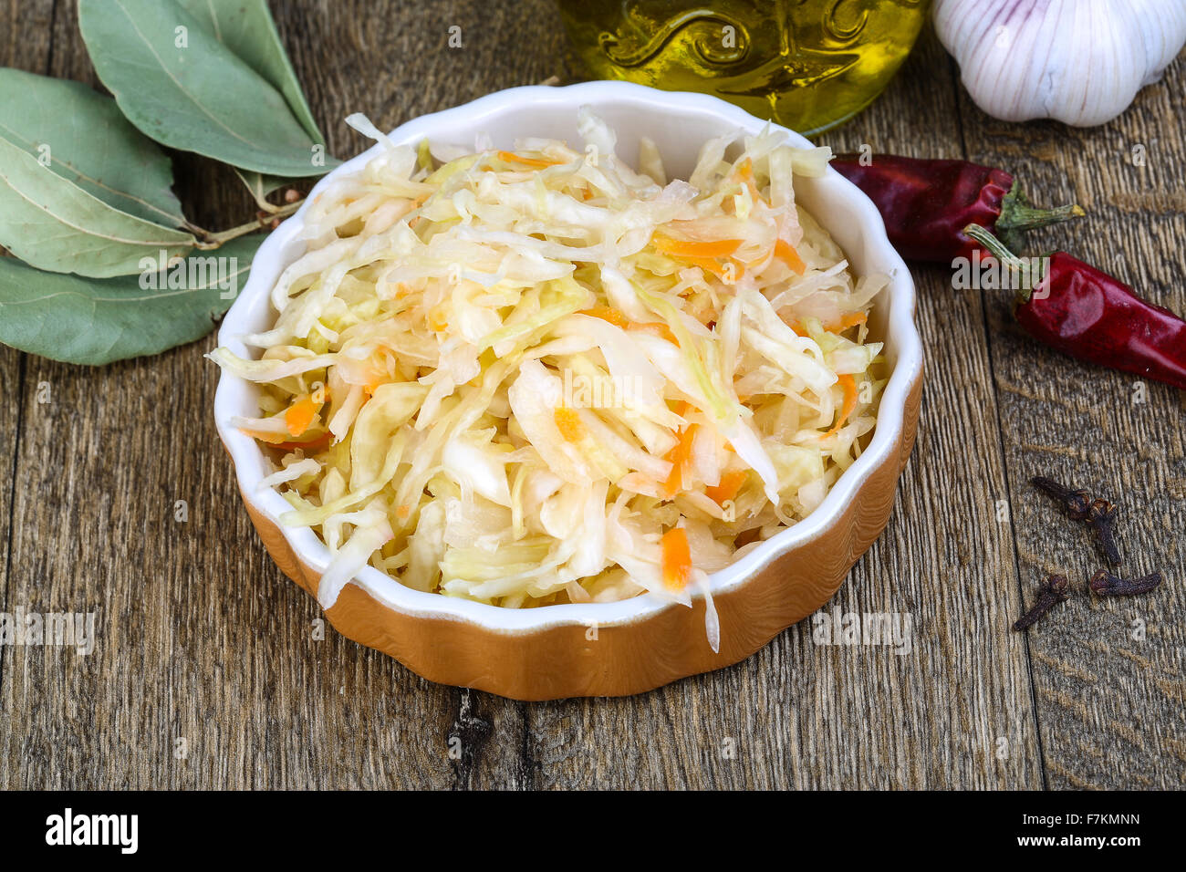 Fermented cabbage - Sauerkraut with herbs and spices on the wood ...