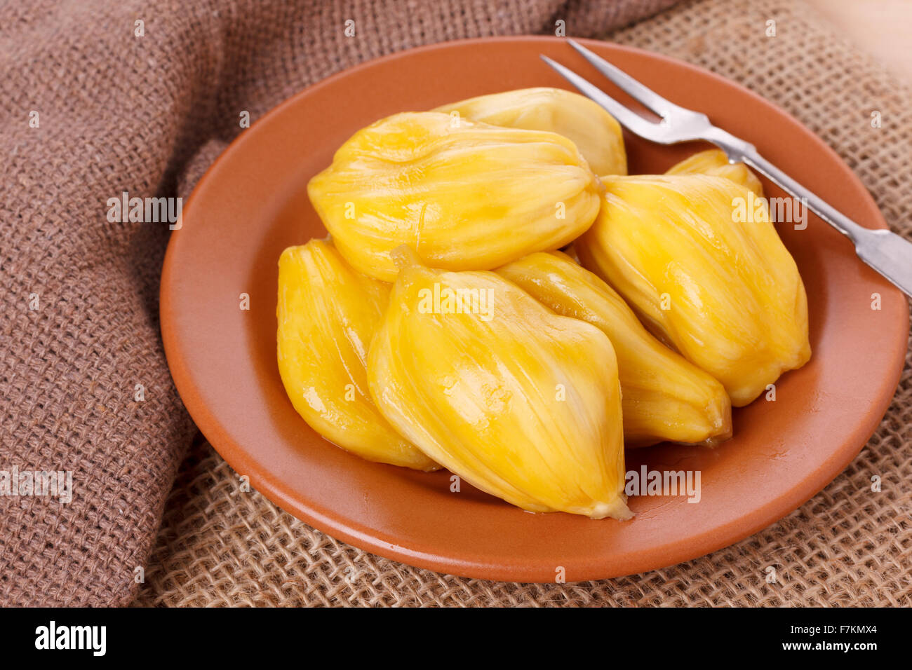 Tropical fruit Jackfruit (jakfruit, jack, jak) on plate on sackcloth ...