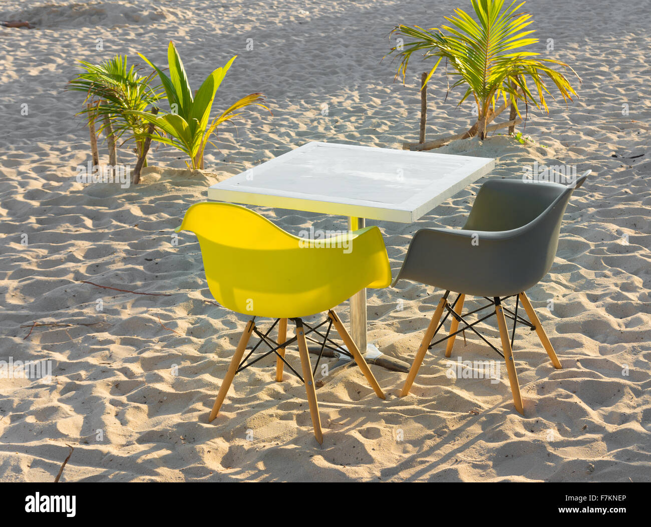 simple table with two chairs on a tropical beach Stock Photo - Alamy