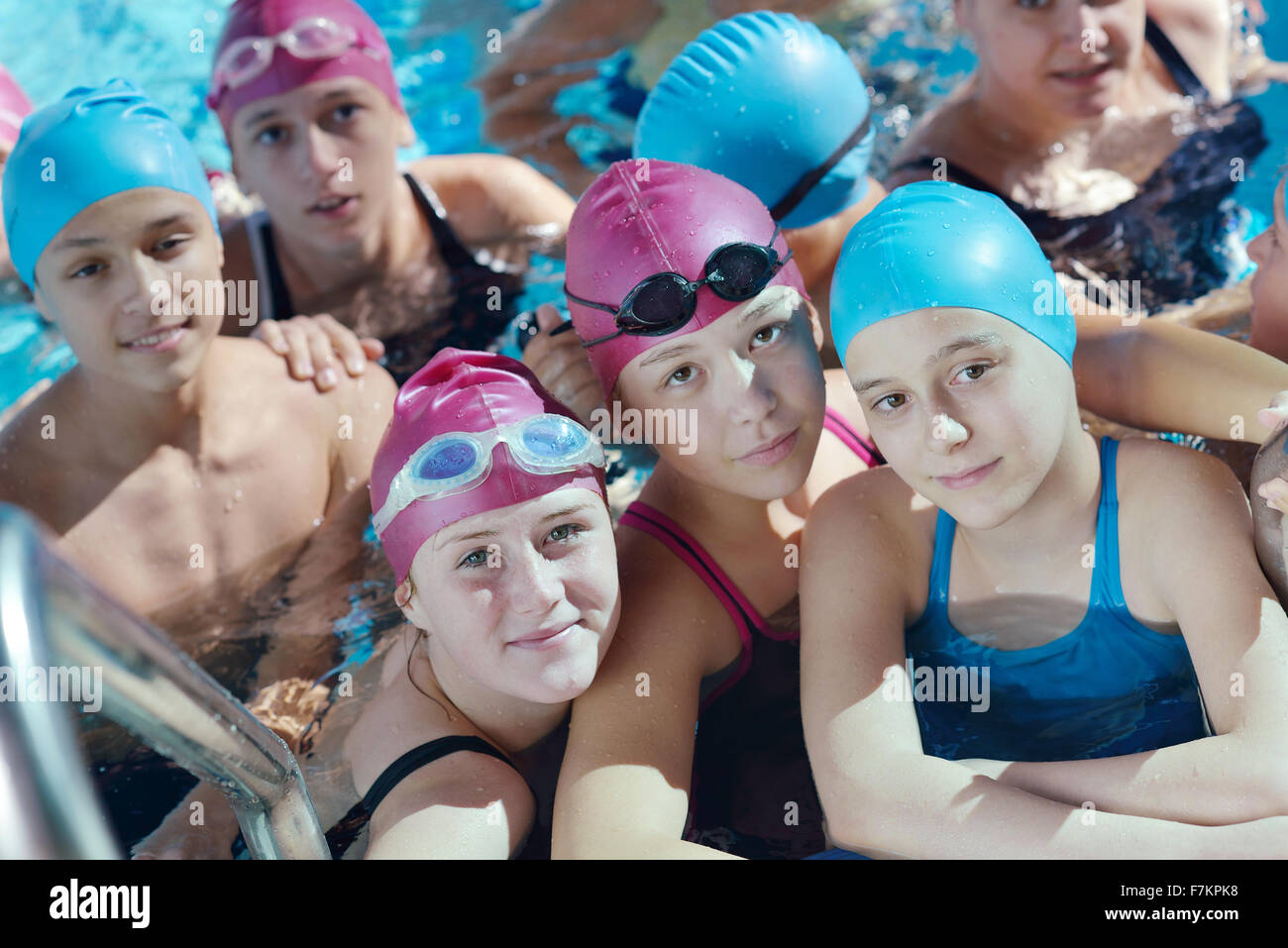 happy children kids group at swimming pool class learning to swim Stock ...