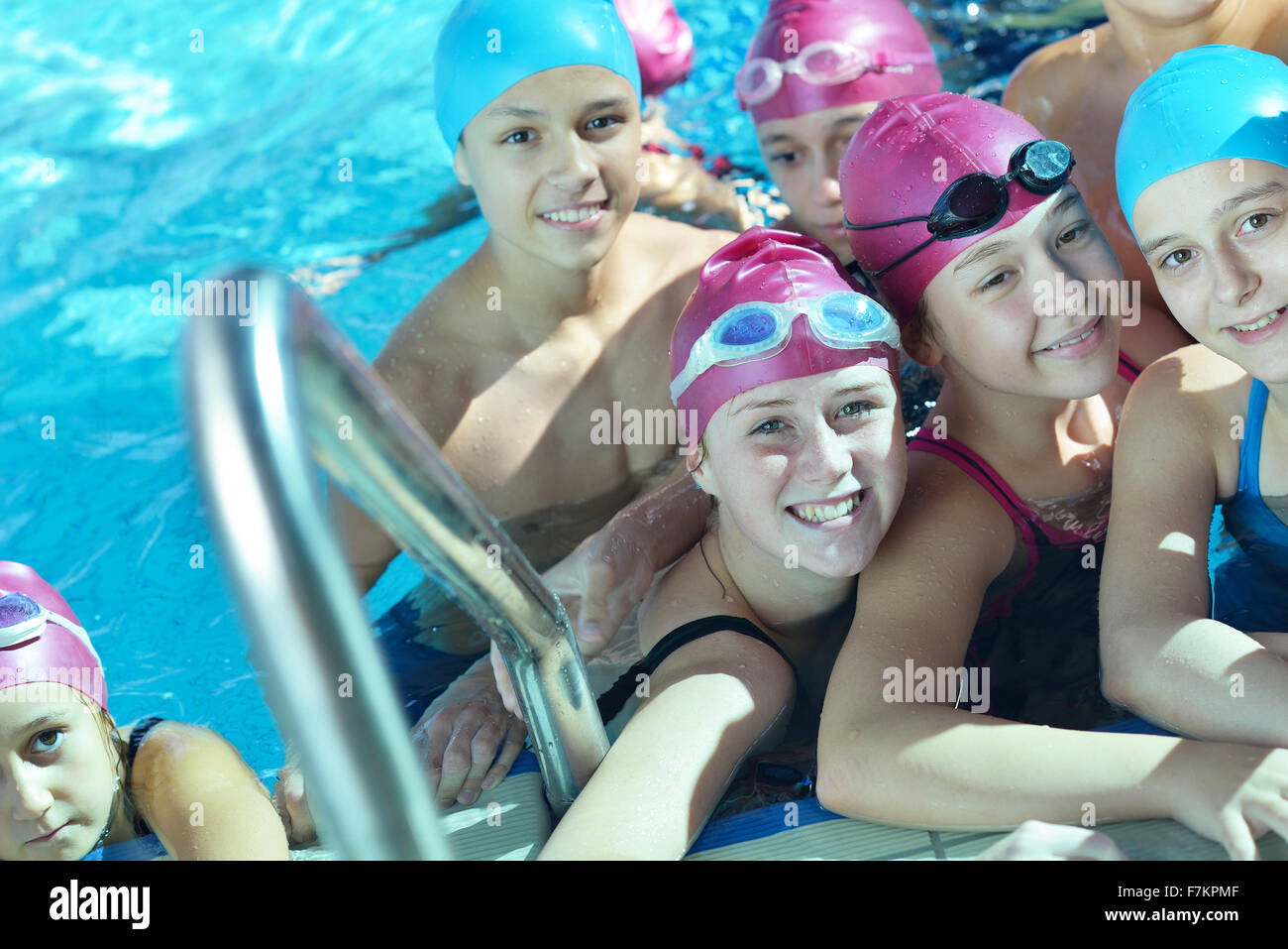 happy children kids group at swimming pool class learning to swim Stock ...