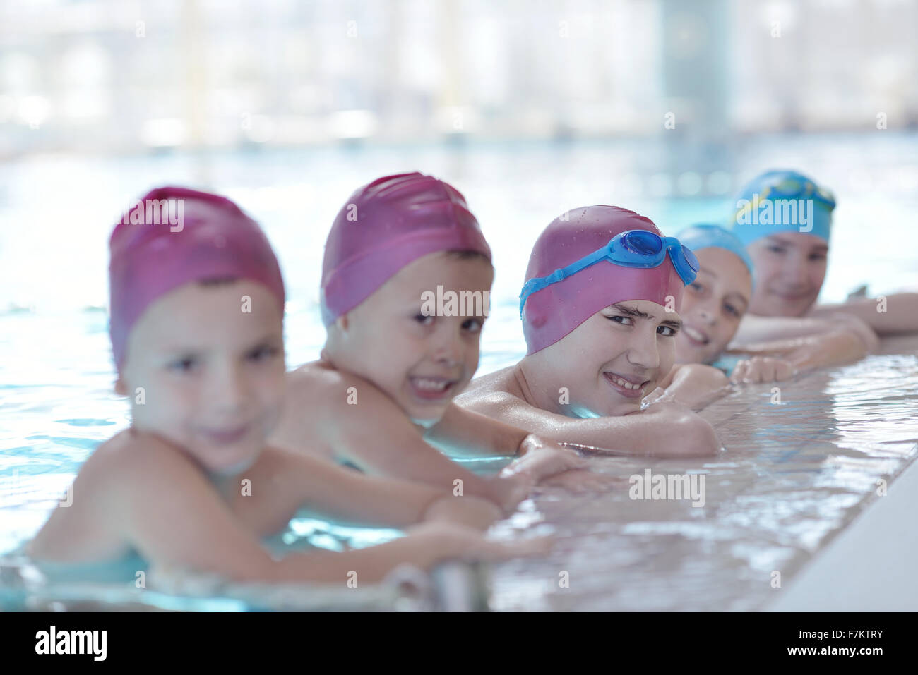 happy children kids group at swimming pool class learning to swim Stock ...