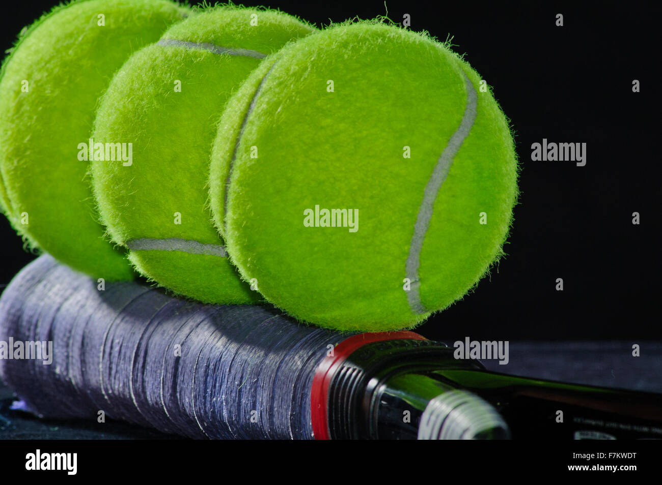 Three tennis balls balanced on a racquet Stock Photo - Alamy