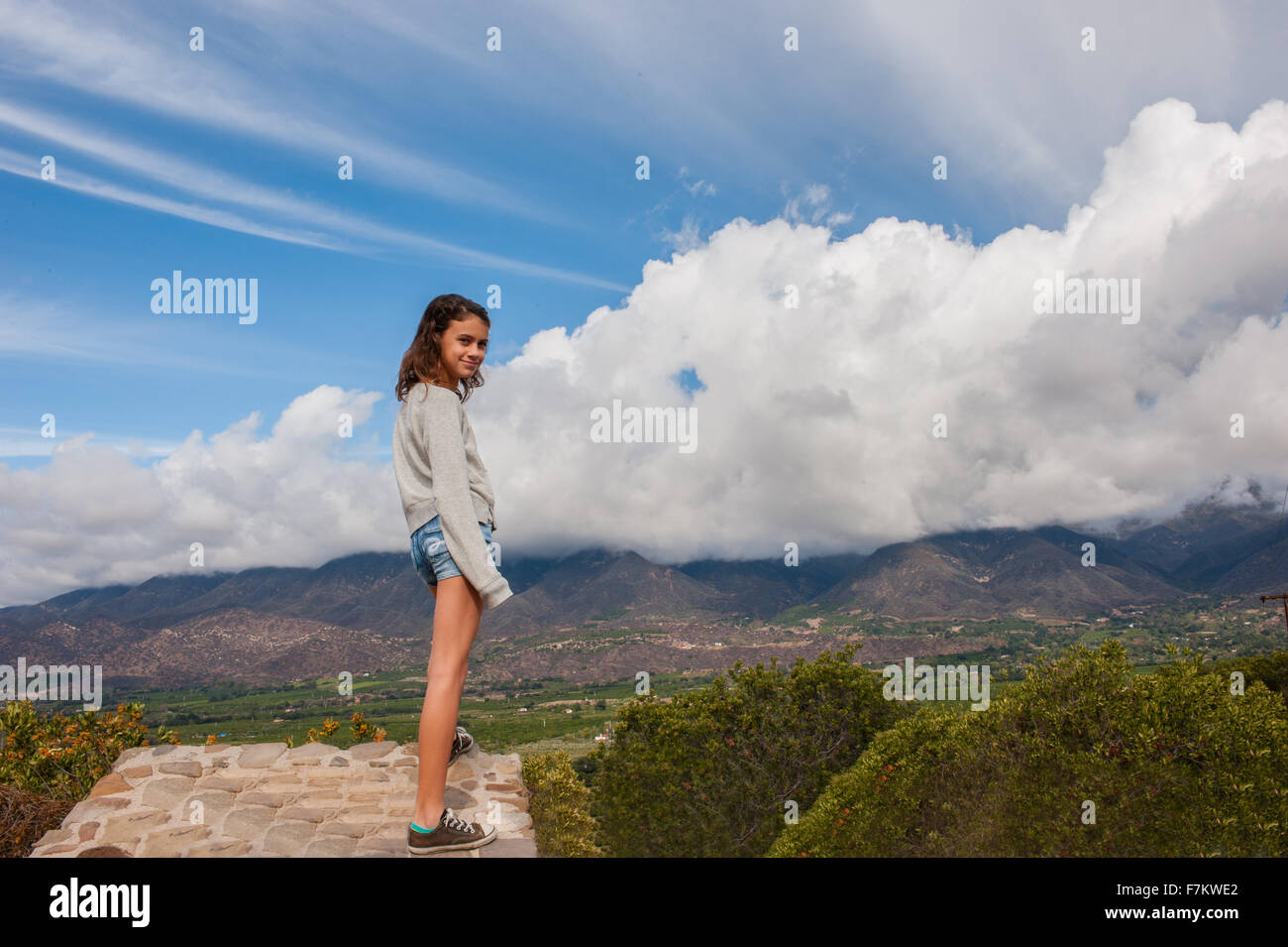 Girl child looking over valley below Stock Photo - Alamy