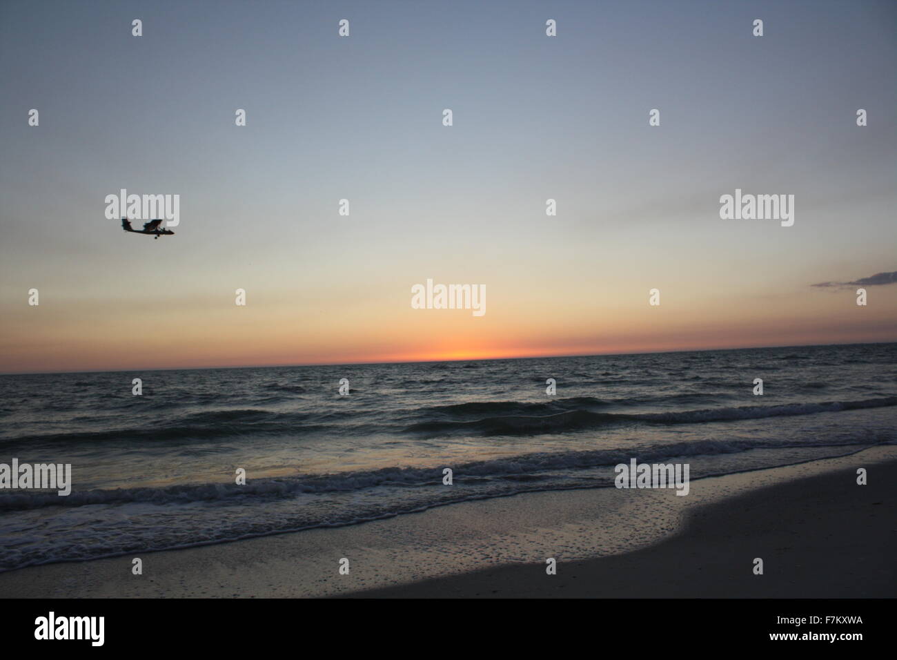 Plane over the ocean Stock Photo - Alamy
