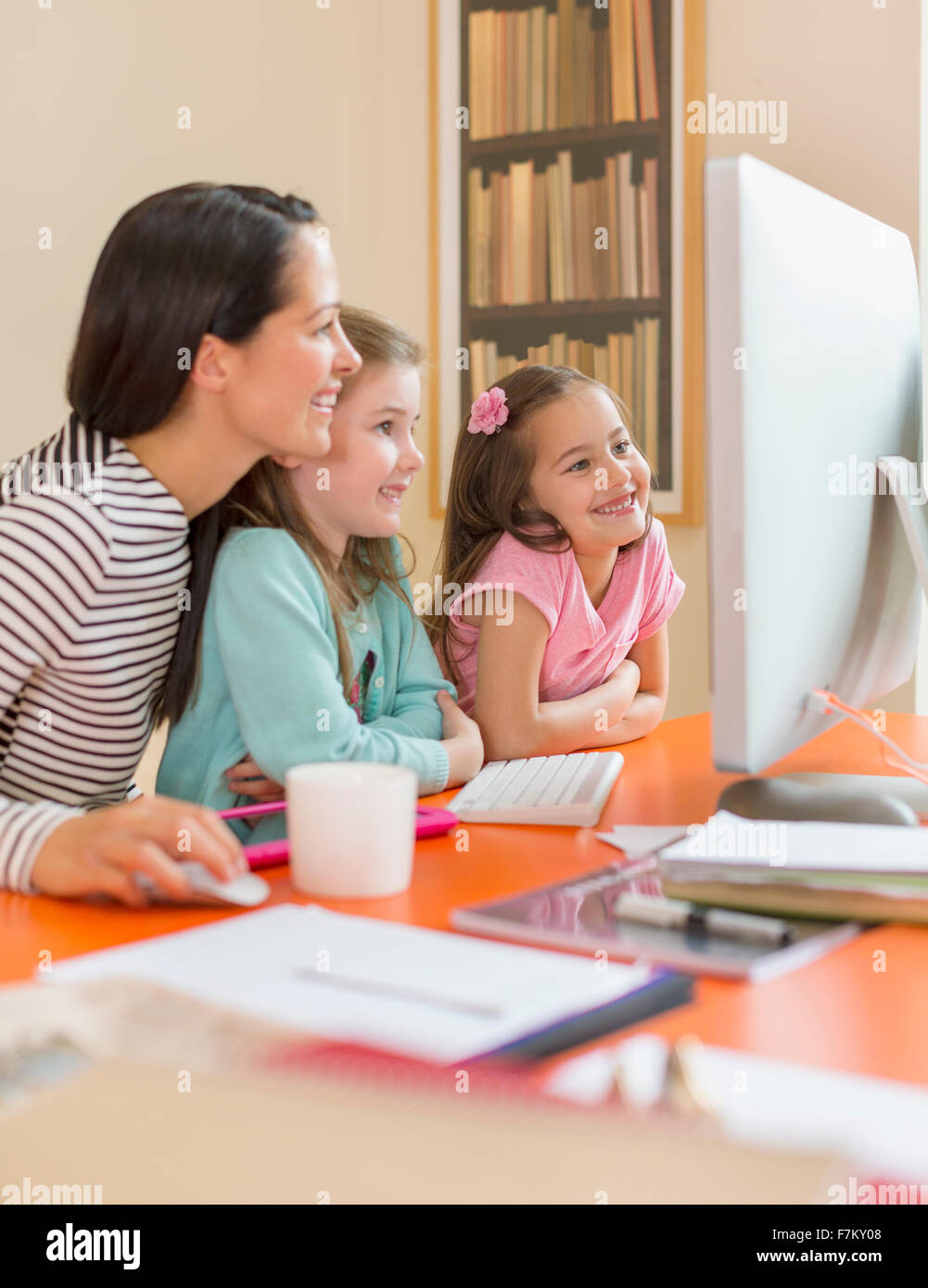 Mother and daughters using computer Stock Photo - Alamy