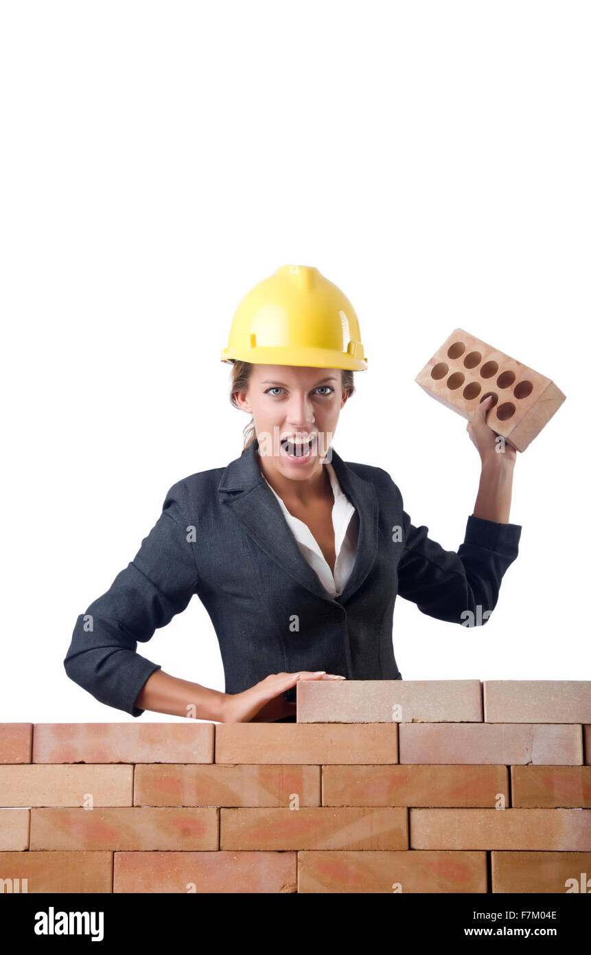 Young female builder near brick wall Stock Photo - Alamy